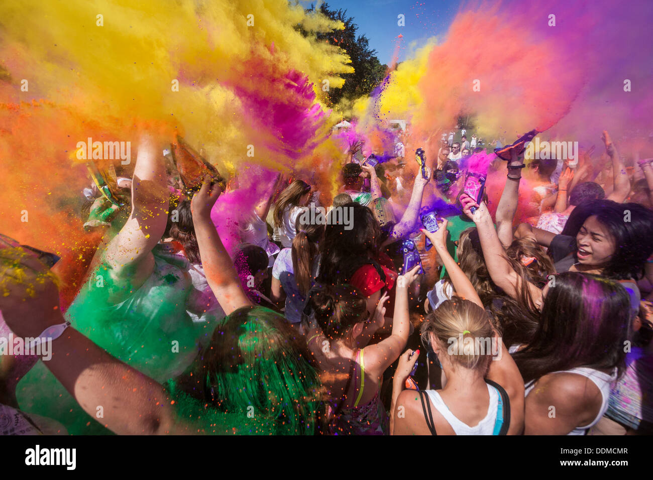 people throwing rainbow coloured powder in a crowd Stock Photo - Alamy
