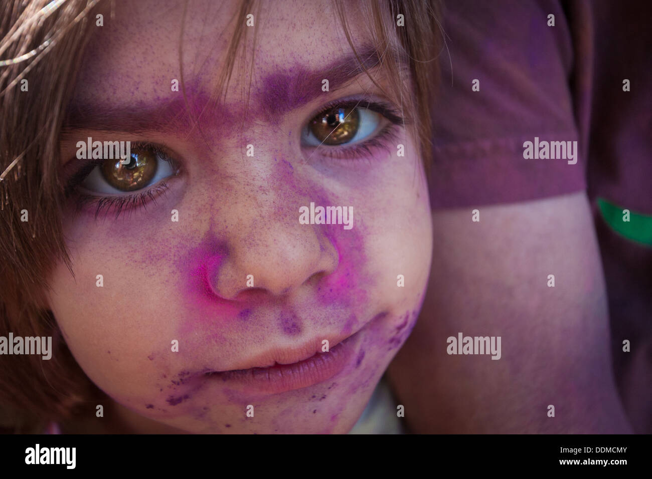 portrait of a little girl with pink and purple powder on her face Stock ...