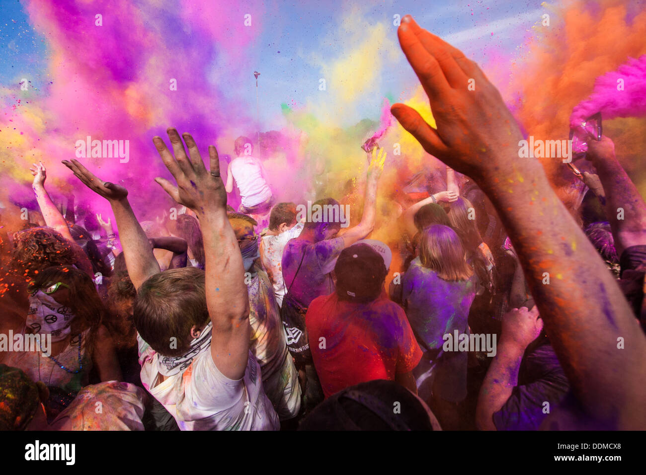 people throwing rainbow coloured powder in a crowd Stock Photo - Alamy