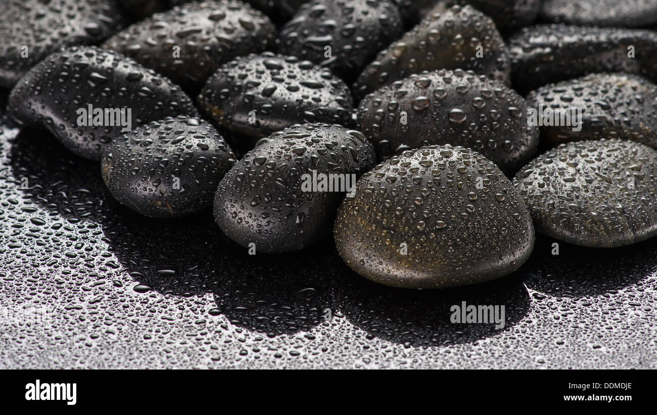 black stone to a Spa in the droplets of water isolated Stock Photo - Alamy