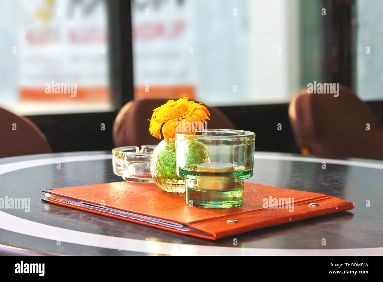 Flower, menu and candle on table in cafe Stock Photo - Alamy