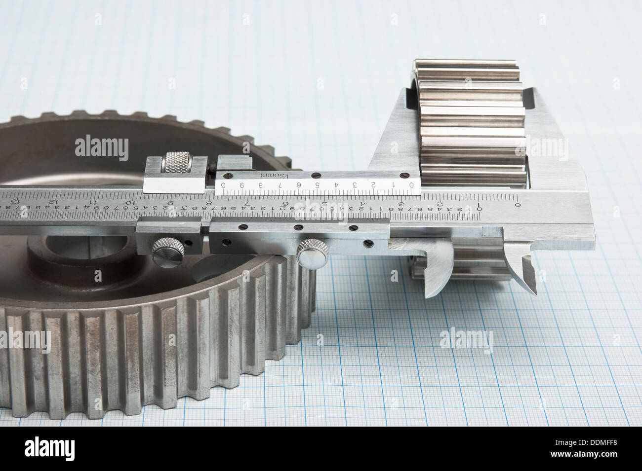 gears and caliper on graph paper Stock Photo - Alamy
