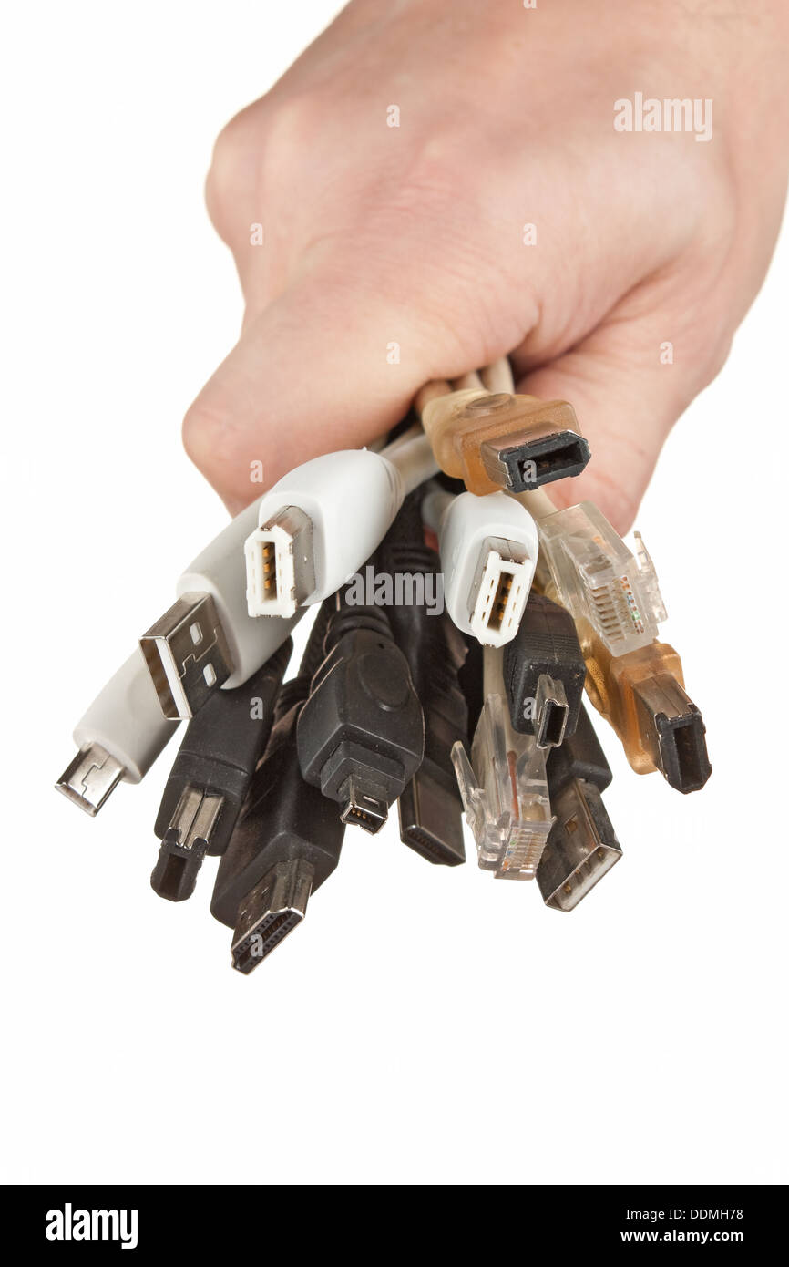 bunch of computer cables with sockets in hand isolated on a white ...