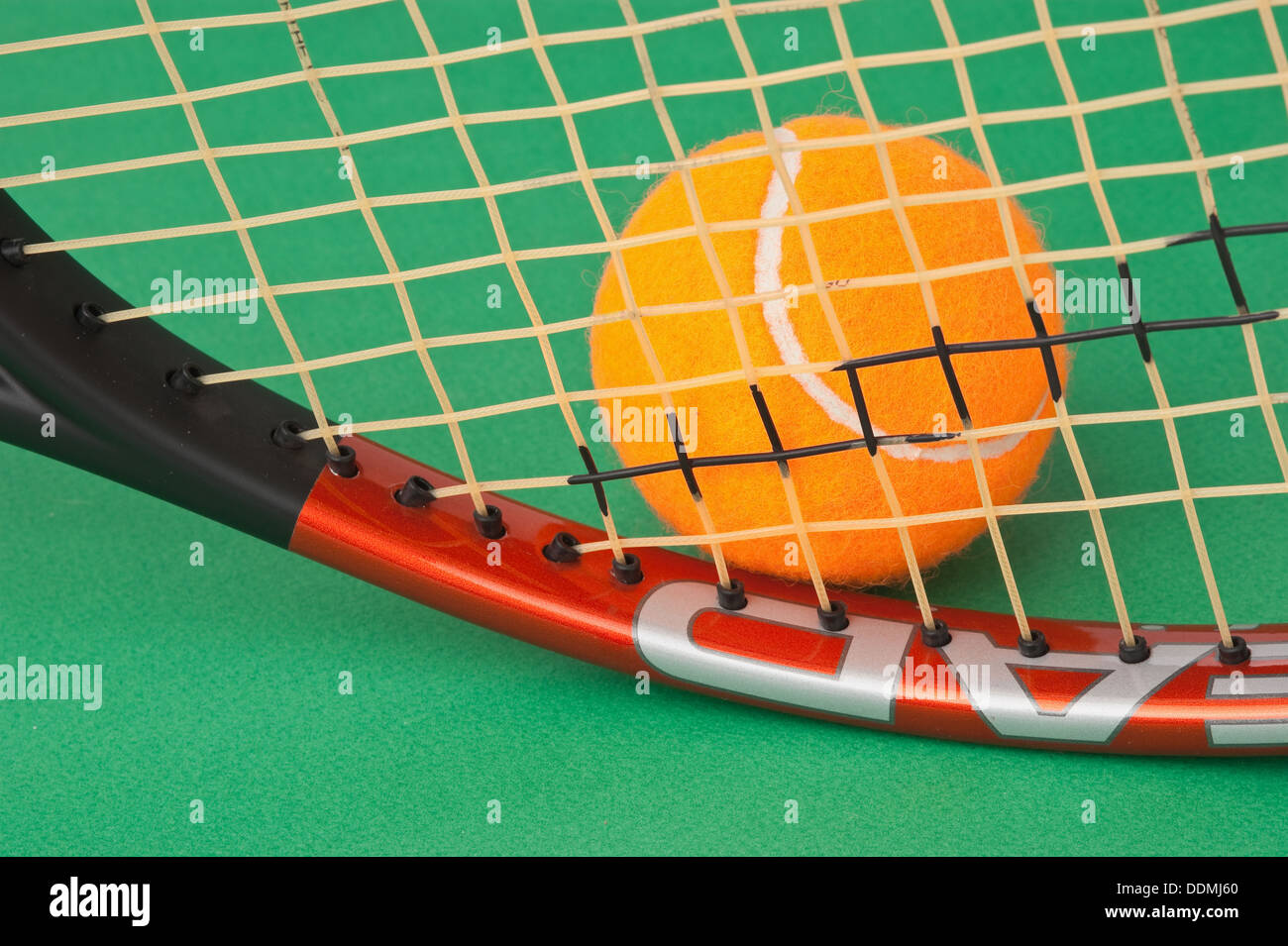 tennis racket and ball on a green background Stock Photo - Alamy