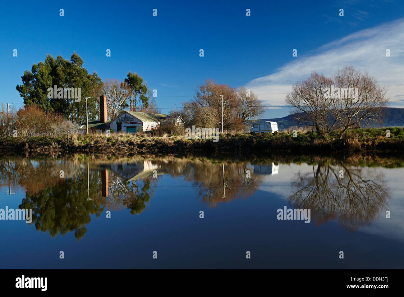 Old Henley Cheese Factory, reflected in Taieri River, Taieri Plains ...