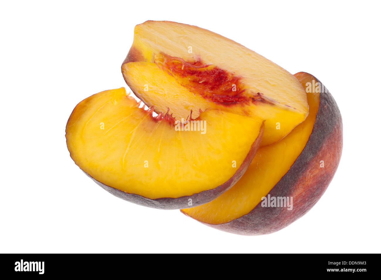 Half a peach cut in parts and isolated in white background Stock Photo ...