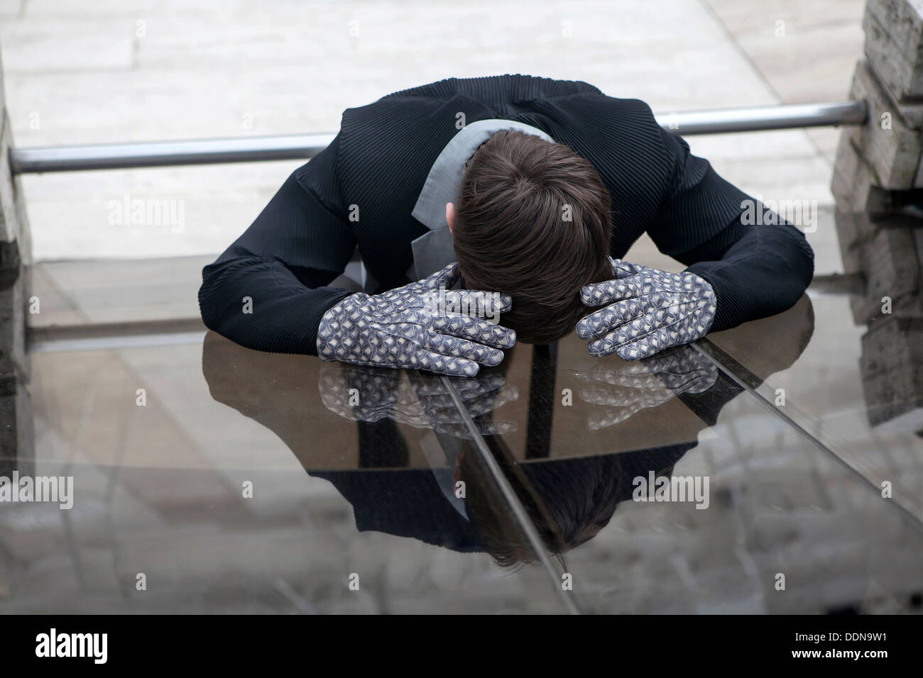 young man looking through the glass wall Stock Photo - Alamy