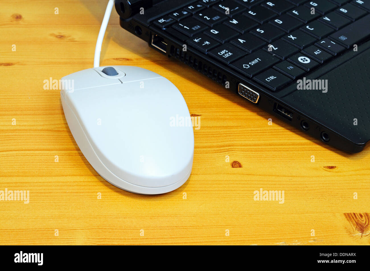 Computer mouse and netbook Stock Photo - Alamy