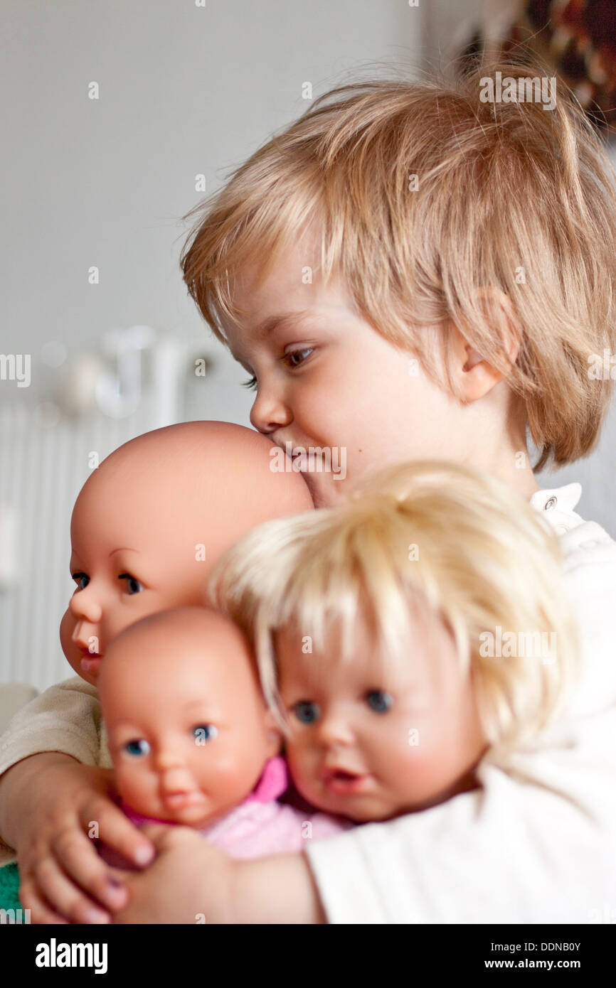 Blond girl embracing her puppets Stock Photo - Alamy