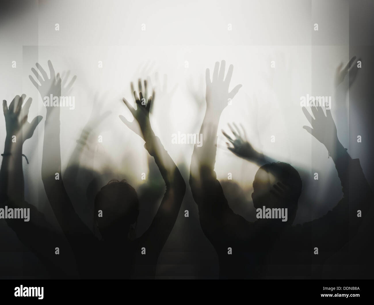 Silhouette of people with raised hands Stock Photo - Alamy