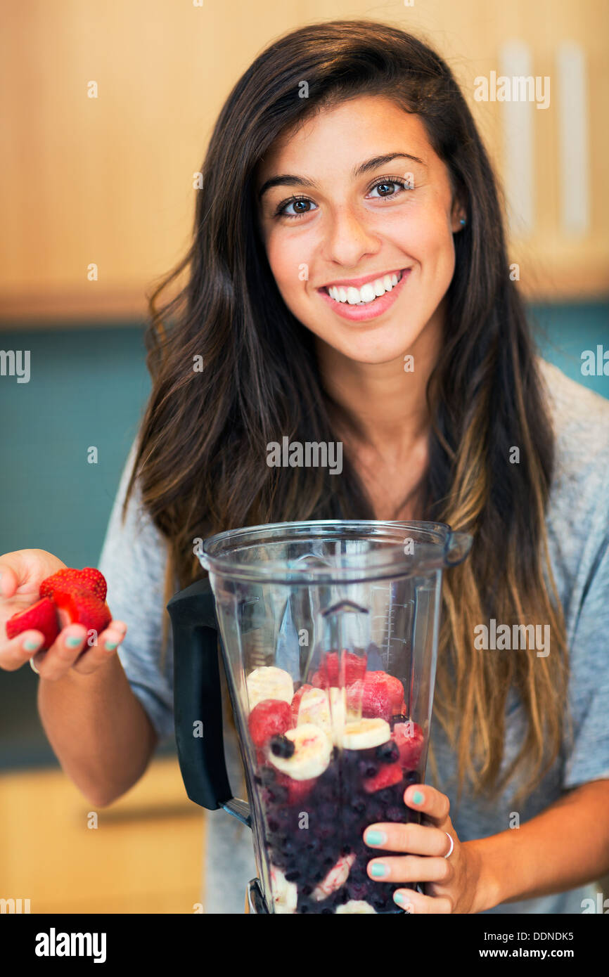 Beautiful Young Woman Making Fruit Smoothie in Blender Stock Photo - Alamy