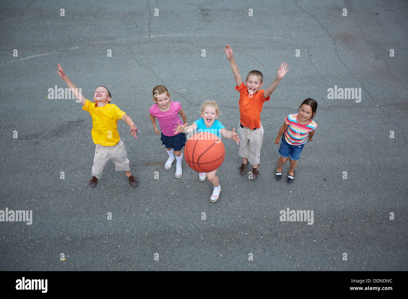 Image of happy friends playing basketball on sports ground Stock Photo ...