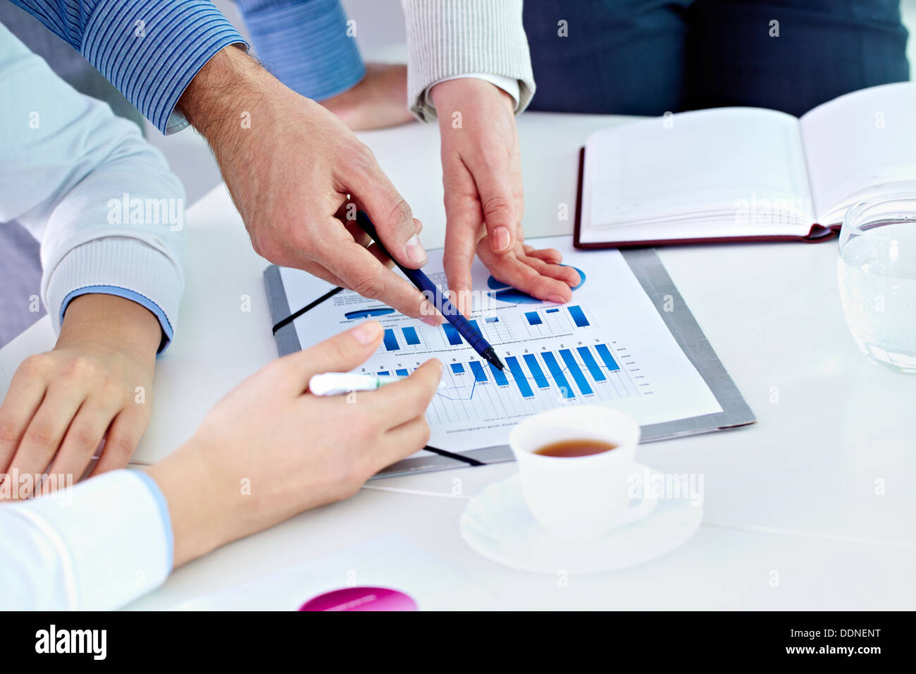 Image of human hands pointing at paper during explanation Stock Photo ...