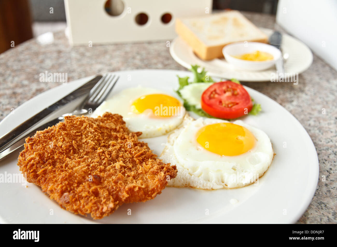Breakfast with fried eggs, toast, and fried fish Stock Photo - Alamy