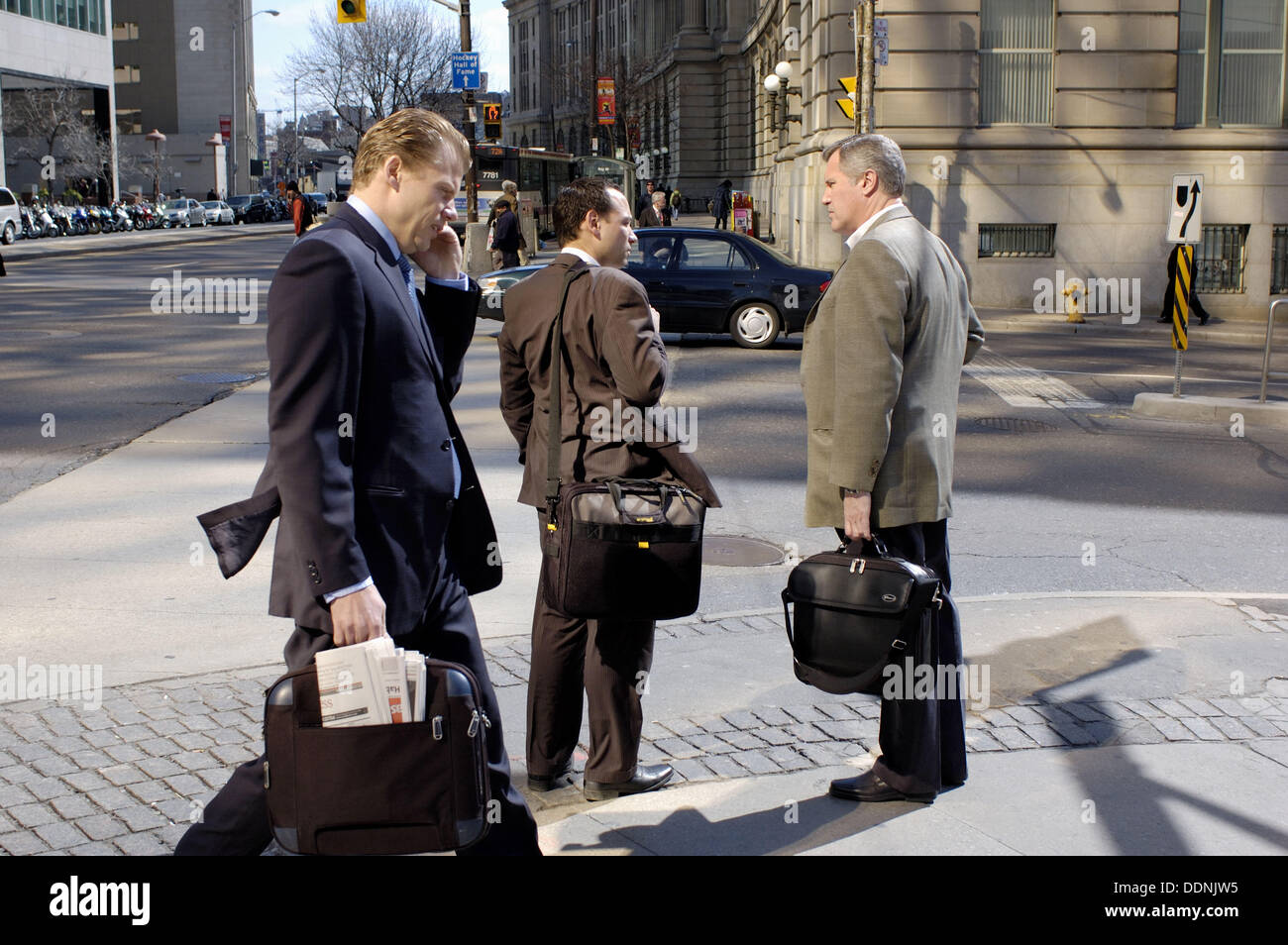 Three men stand talking hi-res stock photography and images - Alamy