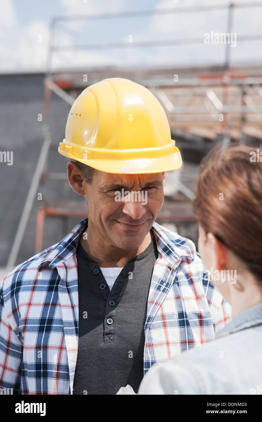 Foreman and client talking on construction site Stock Photo - Alamy