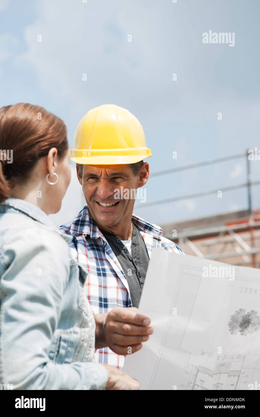 Foreman and client talking on construction site Stock Photo - Alamy