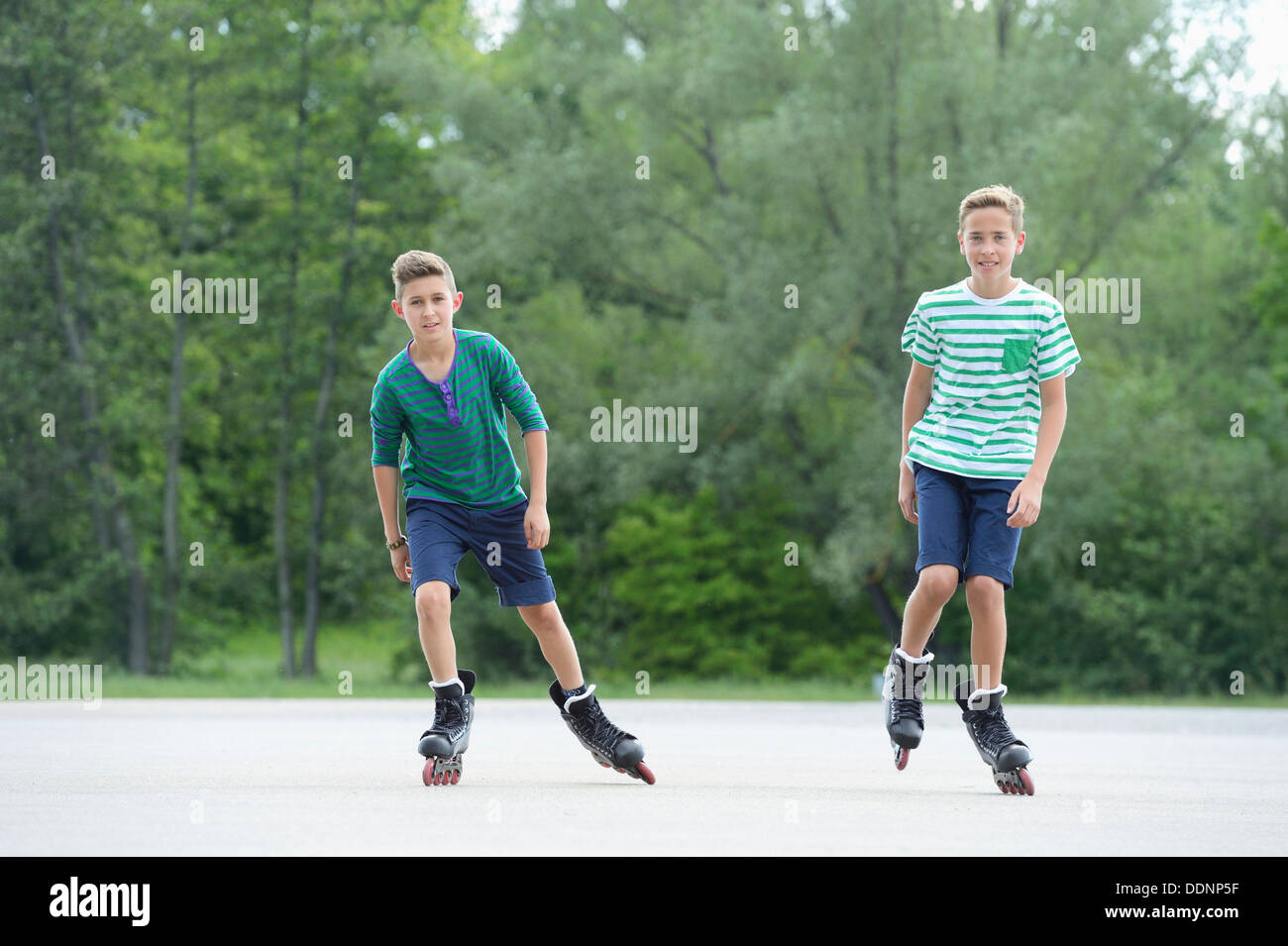 Two boys with in-line skates on a sports place Stock Photo - Alamy