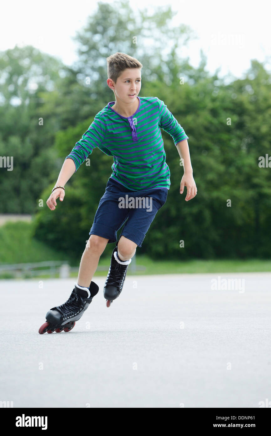 Boy inline skating outdoors hi-res stock photography and images - Alamy