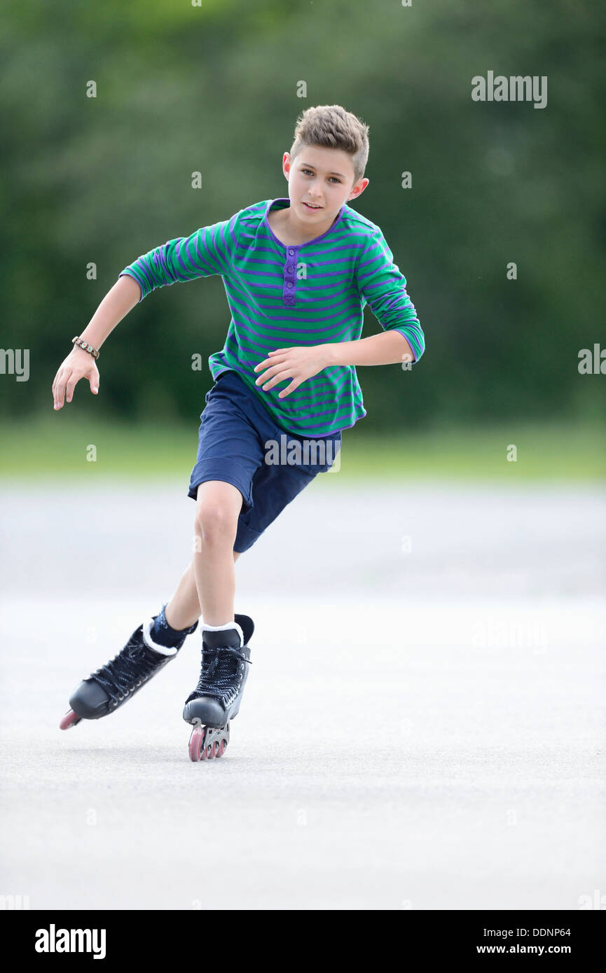 Boy inline skating outdoors hi-res stock photography and images - Alamy