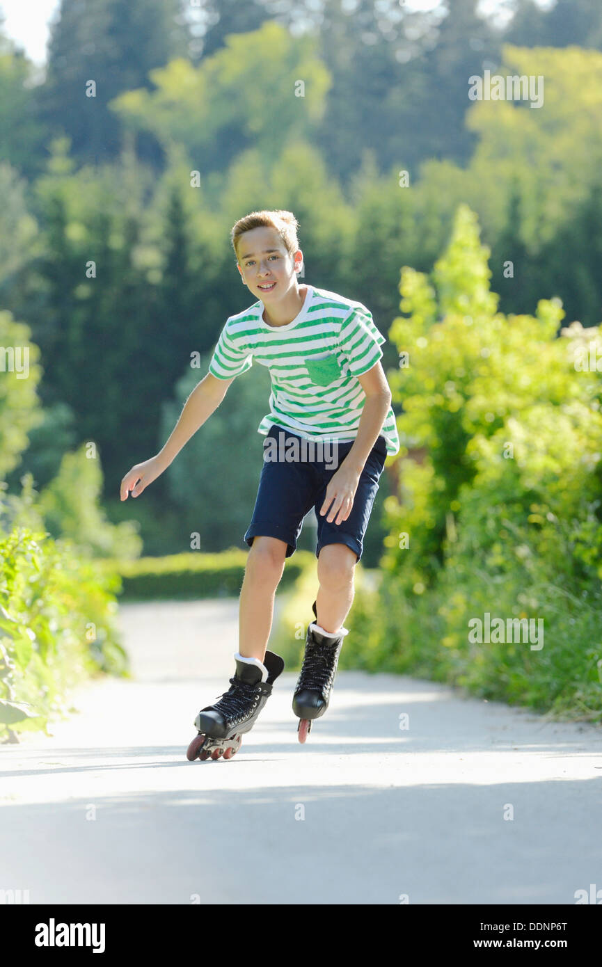 Boy inline skating outdoors hi-res stock photography and images - Alamy
