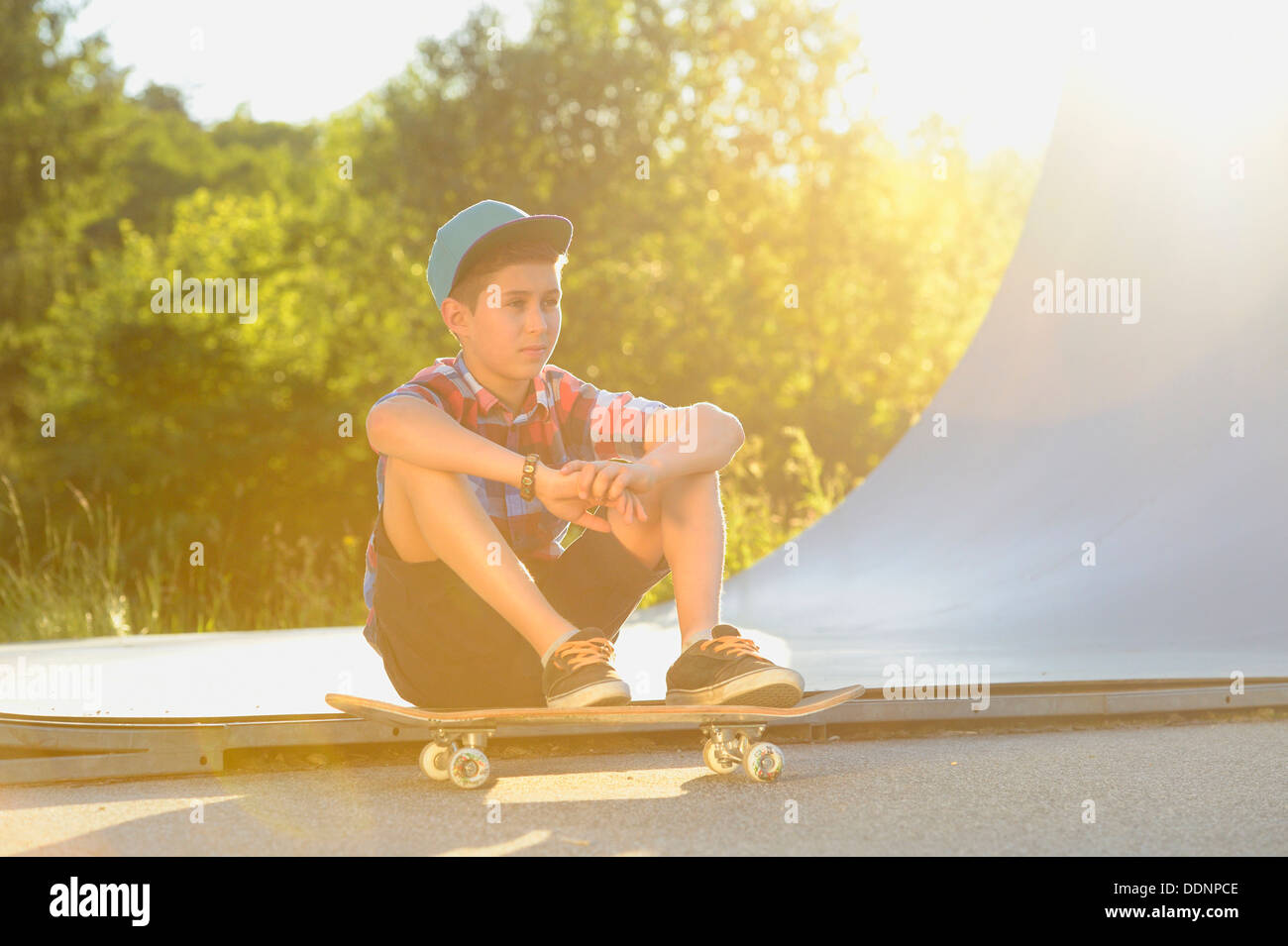 Boy with skateboard in a skatepark Stock Photo - Alamy