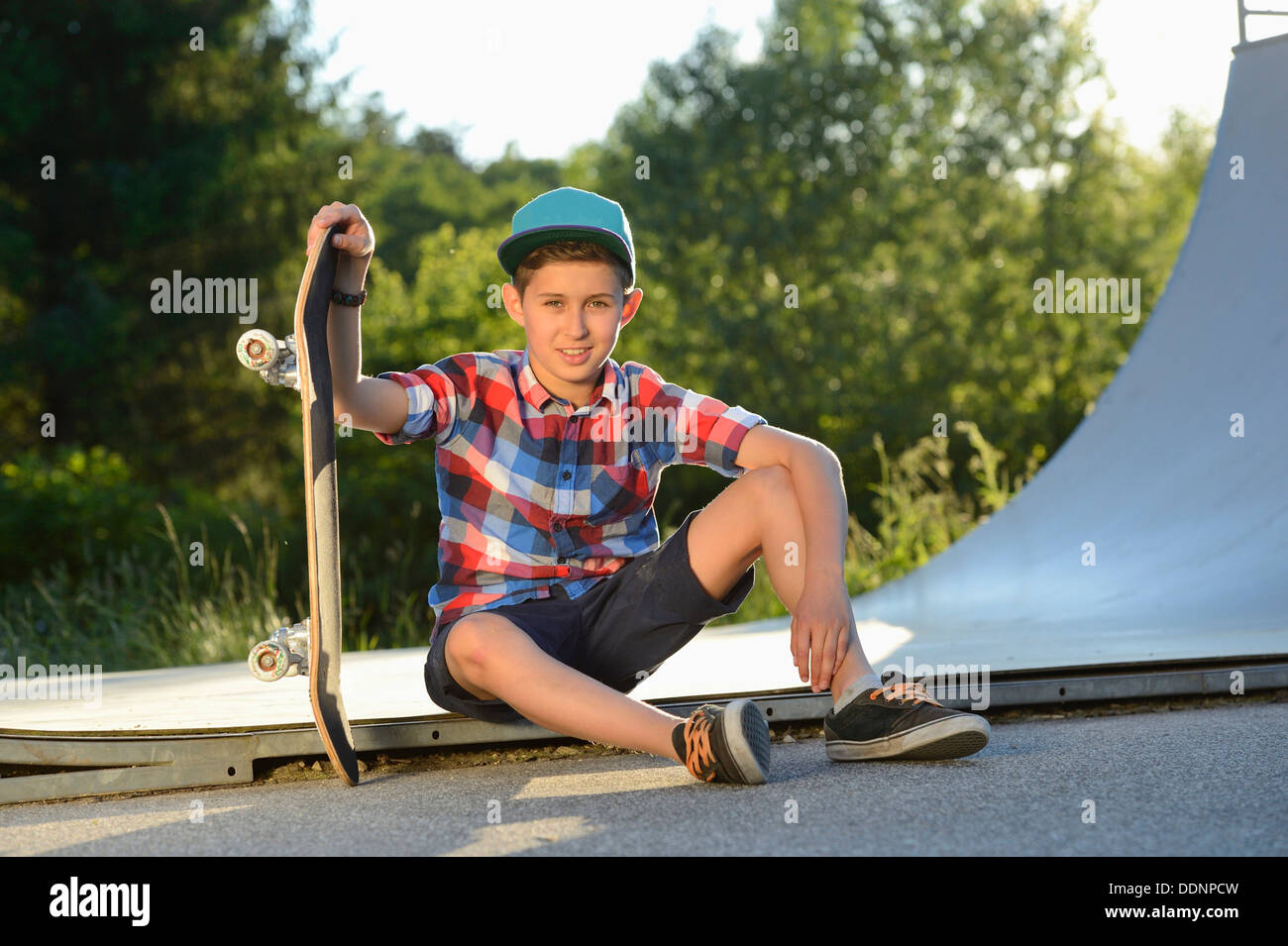 Boy with skateboard in a skatepark Stock Photo - Alamy