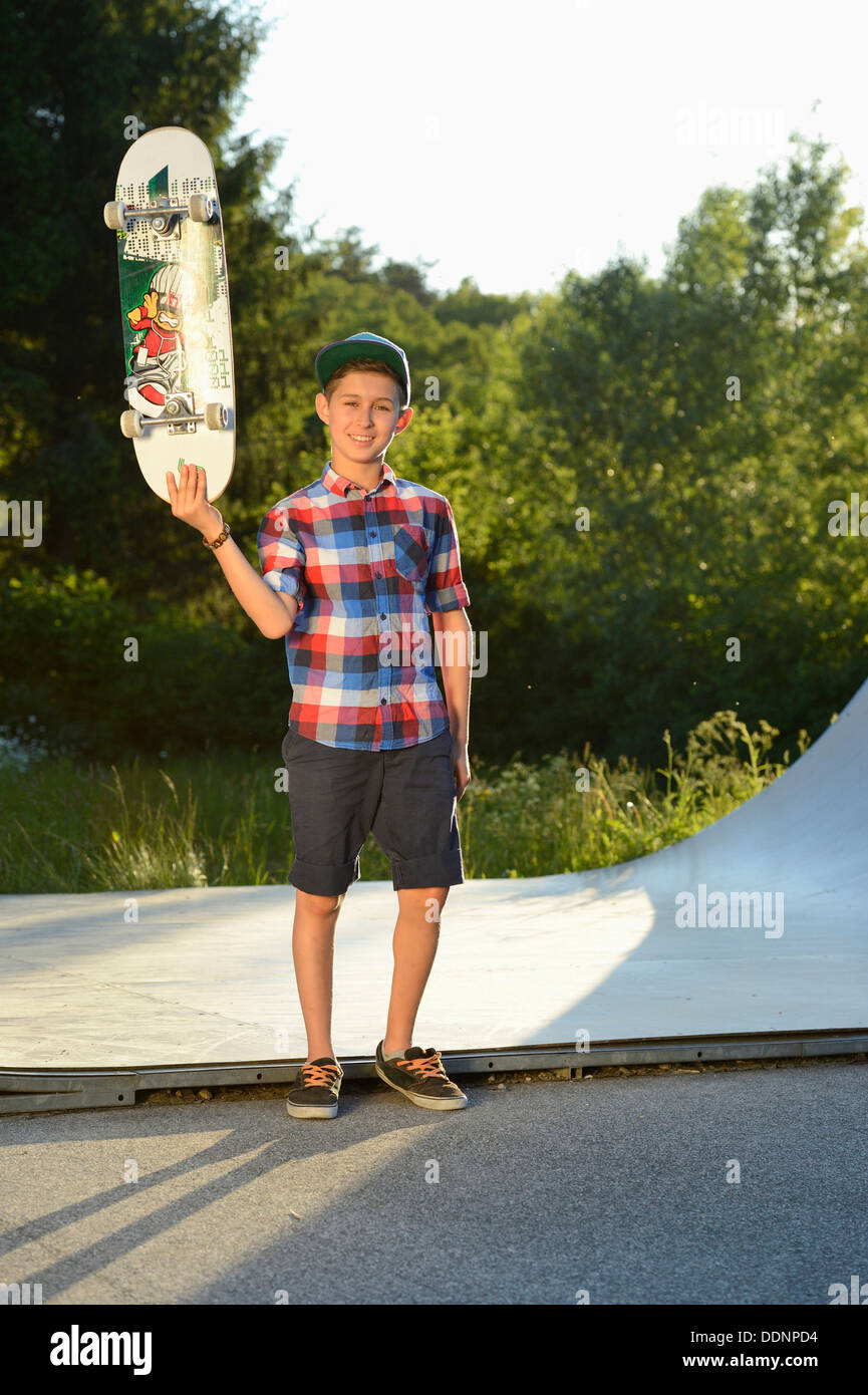 Boy with skateboard in a skatepark Stock Photo - Alamy