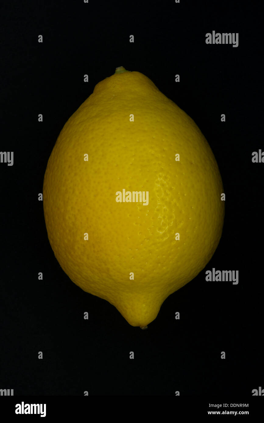 Whole lemon isolated on a black background Stock Photo - Alamy