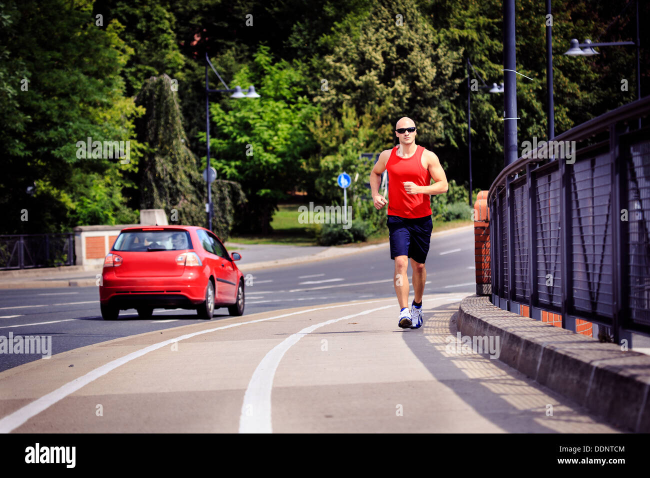 A young man jogging in the city Stock Photo - Alamy