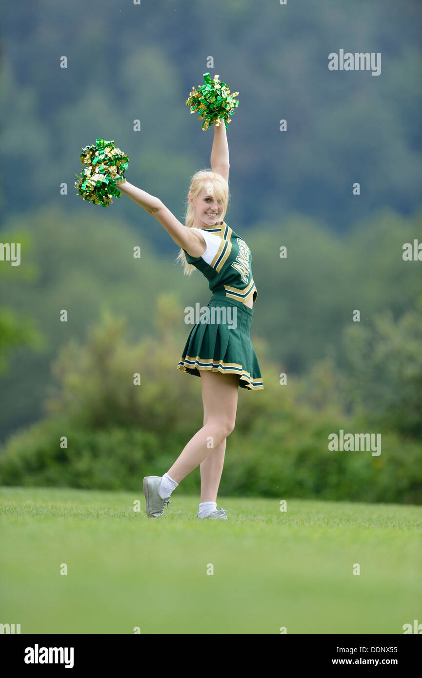 Young woman cheerleading on a meadow Stock Photo - Alamy