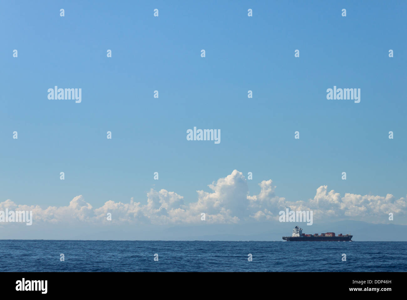 Container ship on the horizon with clouds Stock Photo - Alamy
