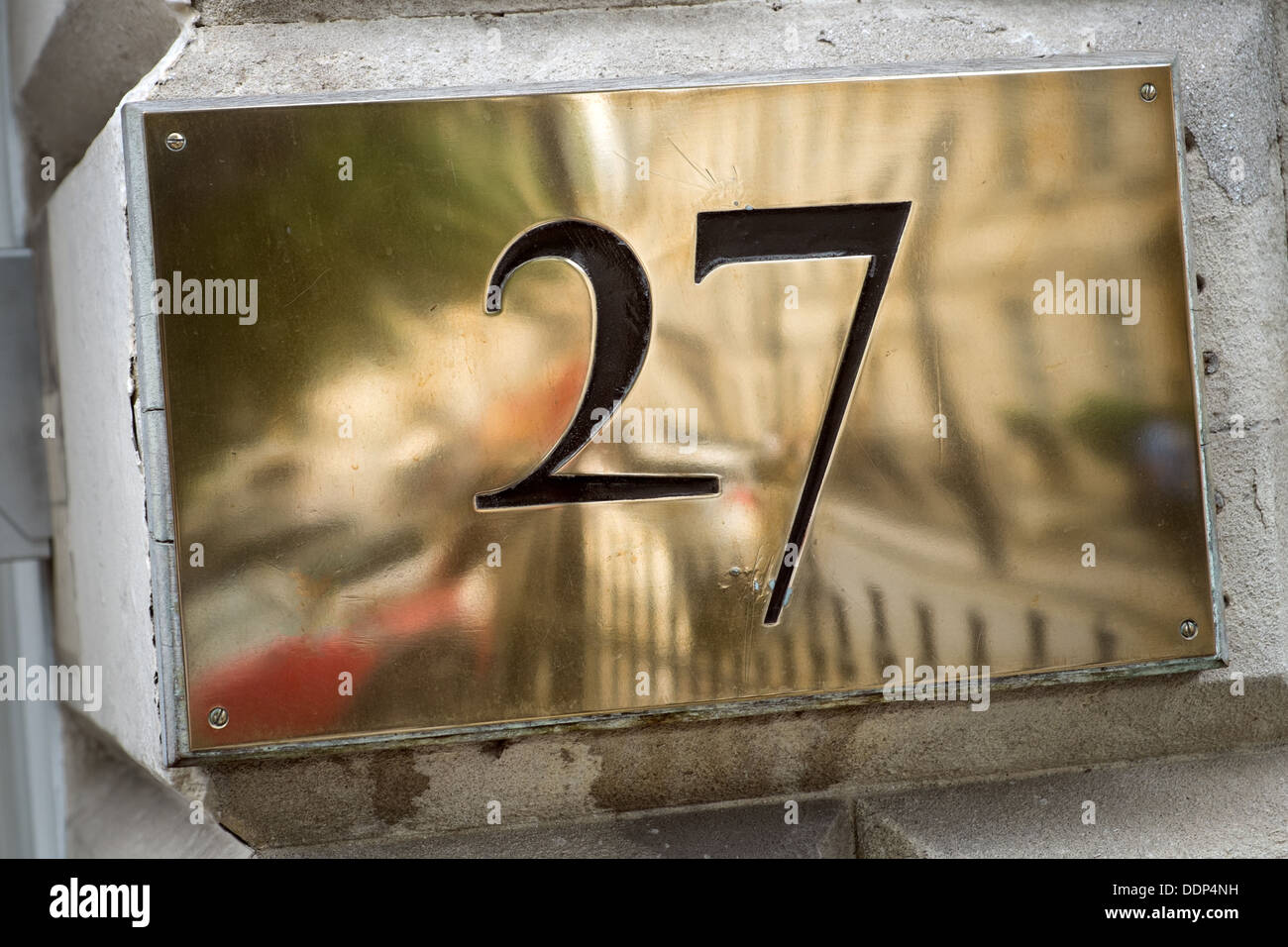 The number 27 on a polished brass plaque Stock Photo - Alamy