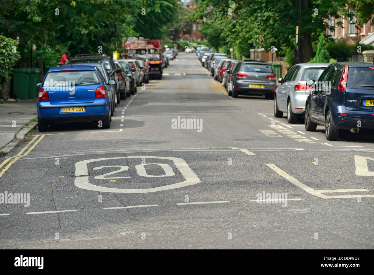 One way street in London, filled with parking cars on both side of the ...