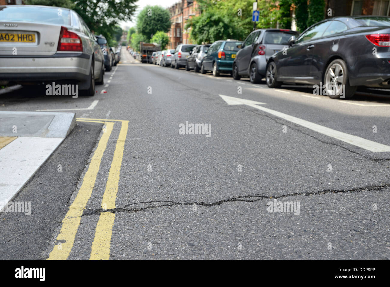 One way street in London, filled with parking cars on both side of the ...