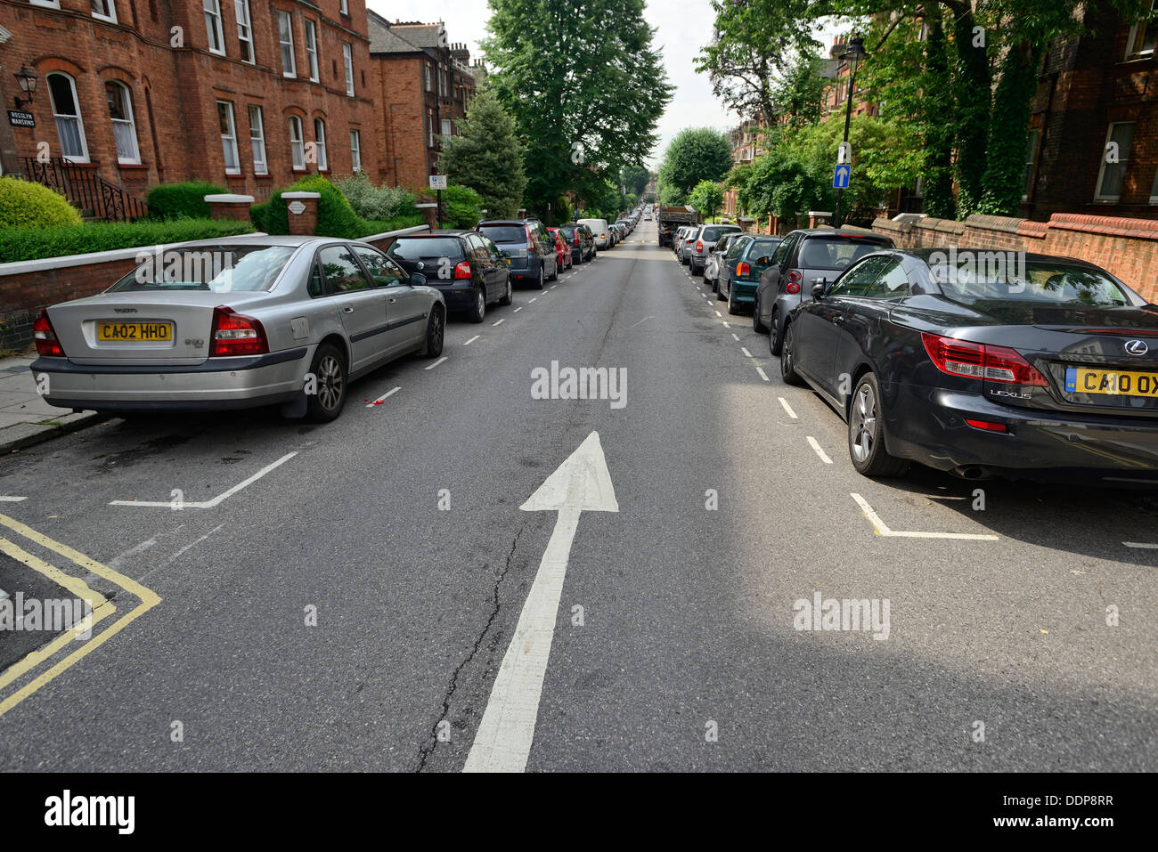 One way street in London, filled with parking cars on both side of the road Stock Photo - Alamy
