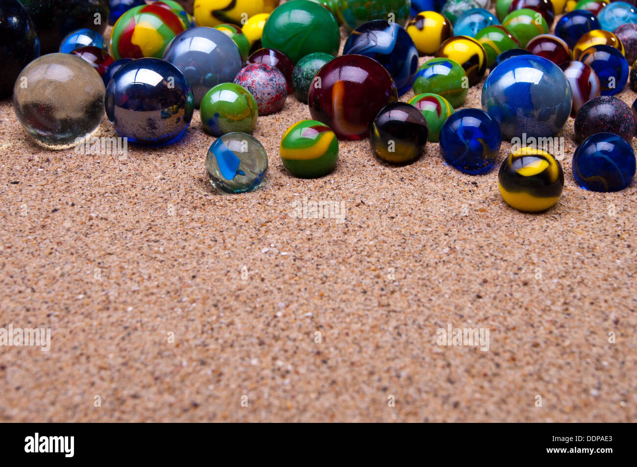 Glass marbles on sand hi-res stock photography and images - Alamy