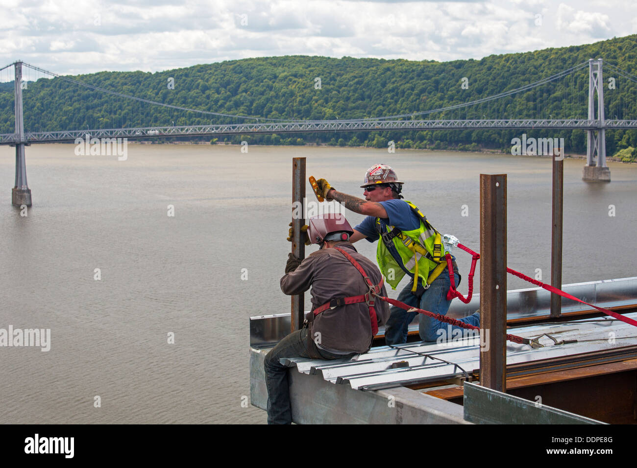 Construction workers on Hudson River pedestrian bridge Stock Photo - Alamy
