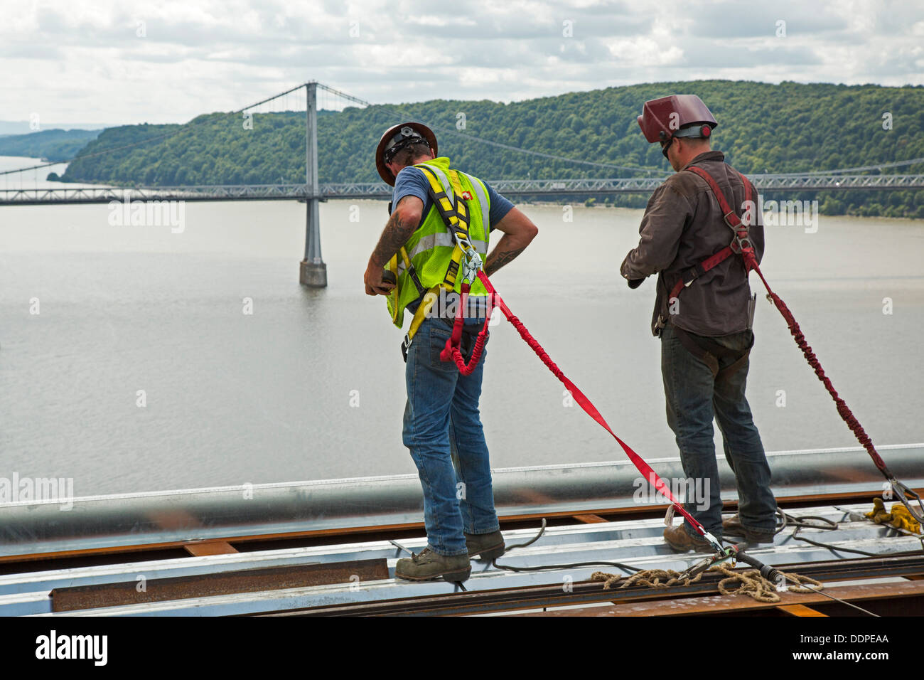 Construction workers on Hudson River pedestrian bridge Stock Photo - Alamy