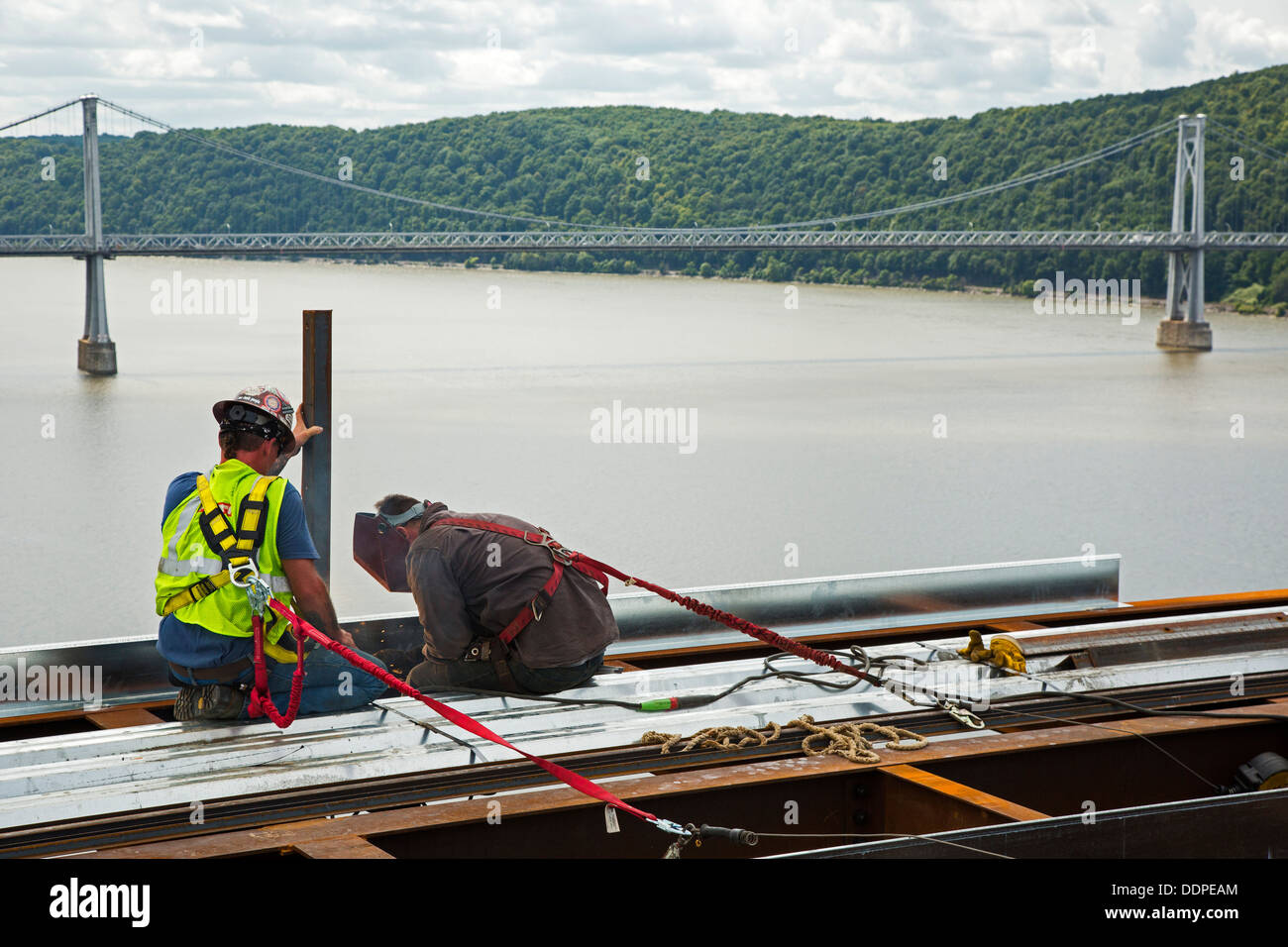 Construction workers on Hudson River pedestrian bridge Stock Photo - Alamy