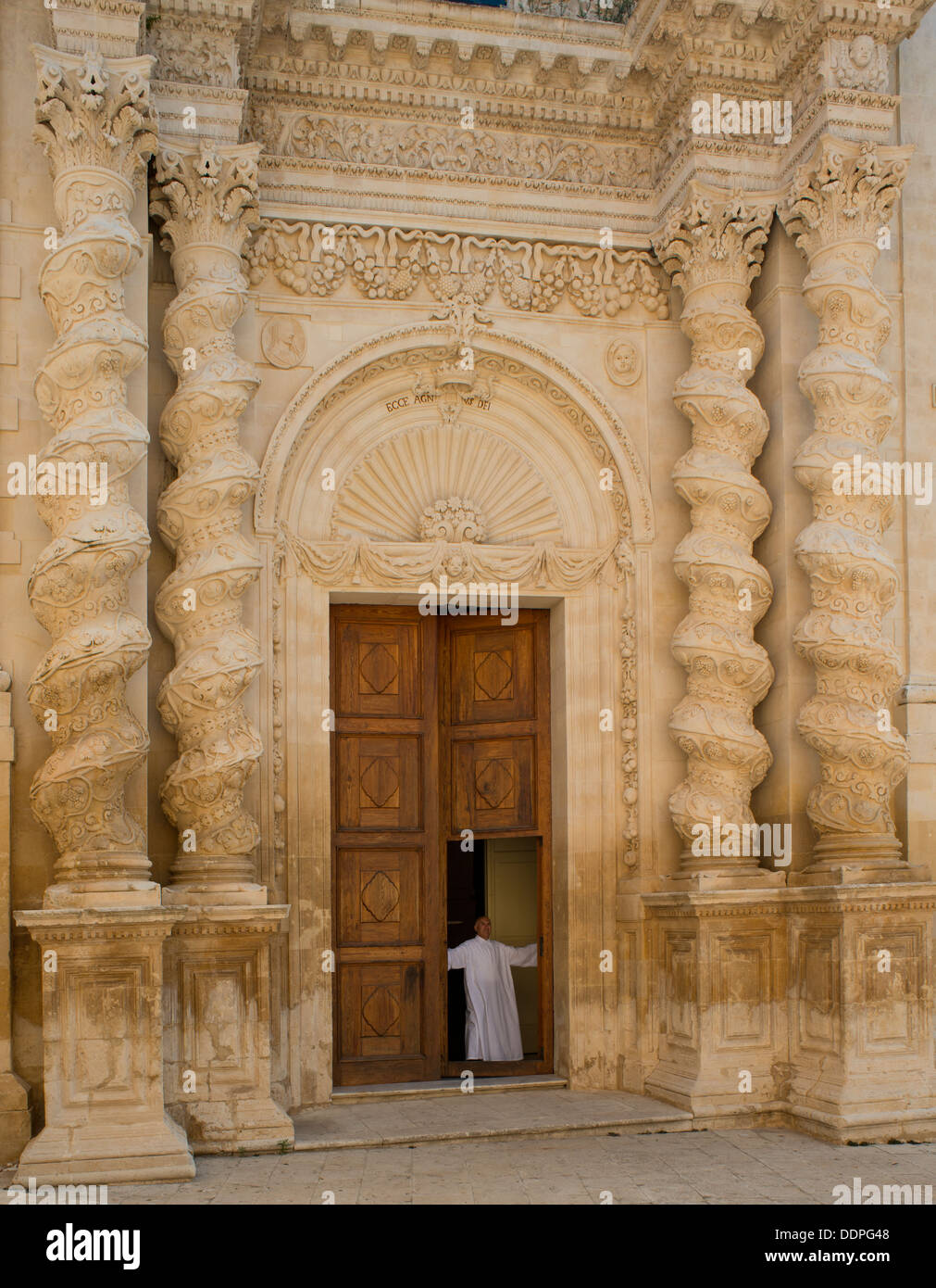 A priest opening the doors of the Church of Annunziata in Palazzolo ...