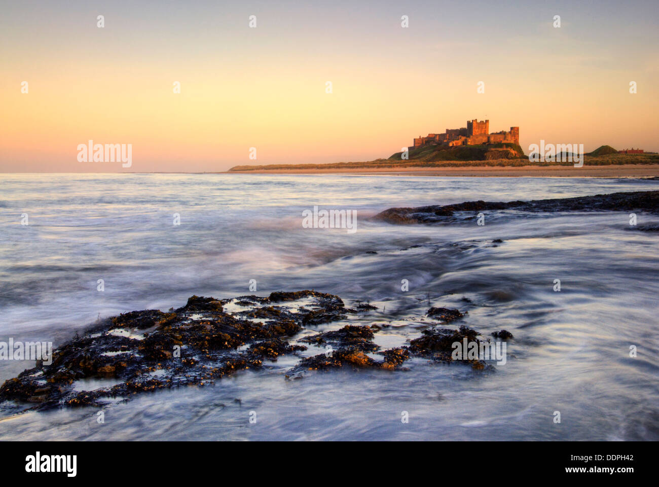 Sunset over Bamburgh Castle, Northumberland Coast, England Stock Photo ...