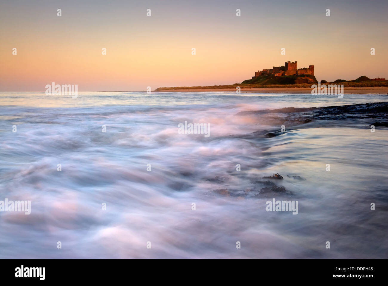 Sunset over Bamburgh Castle, Northumberland Coast, England Stock Photo ...