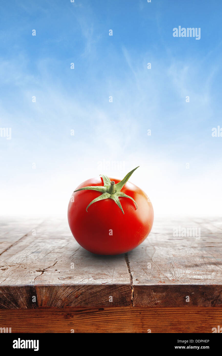 Fresh red tomato on vintage wooden table top Stock Photo - Alamy