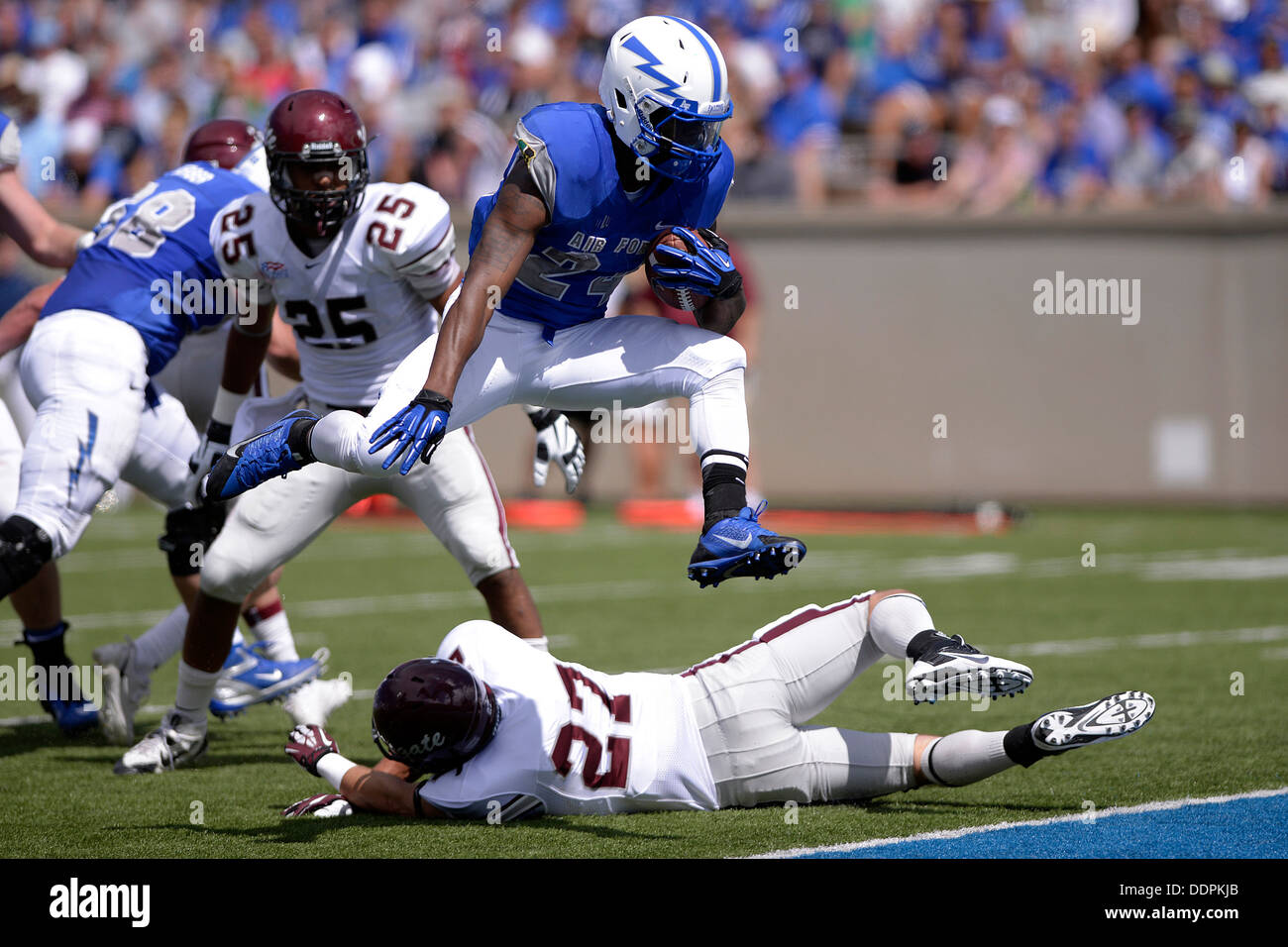 Junior running back Jon Lee leaps into the end zone for a touchdown as ...