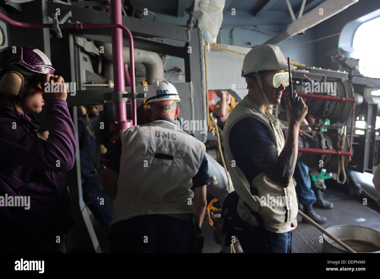 Boatswain's Mate 1st Class Tony Layton (right), radios in instructions ...