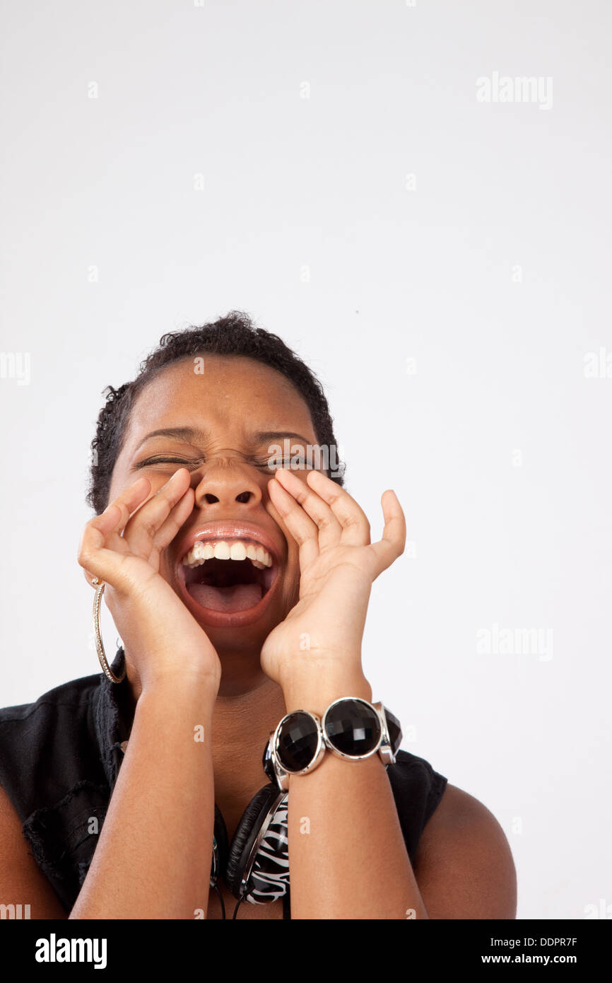 Pretty black woman with earphones, yelling at the camera with a ...