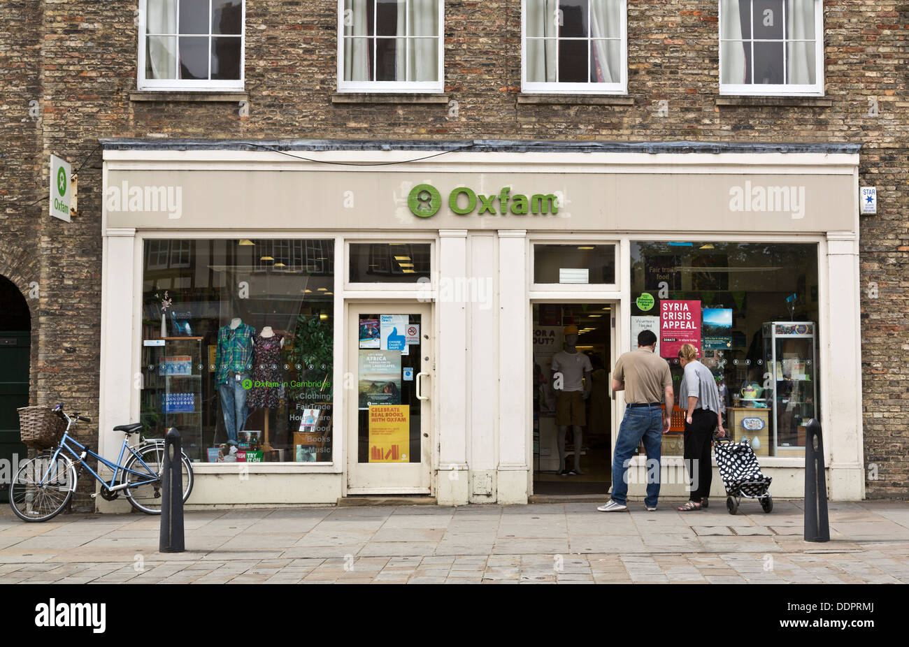 People looking through window of Oxfam charity shop in Cambridge ...