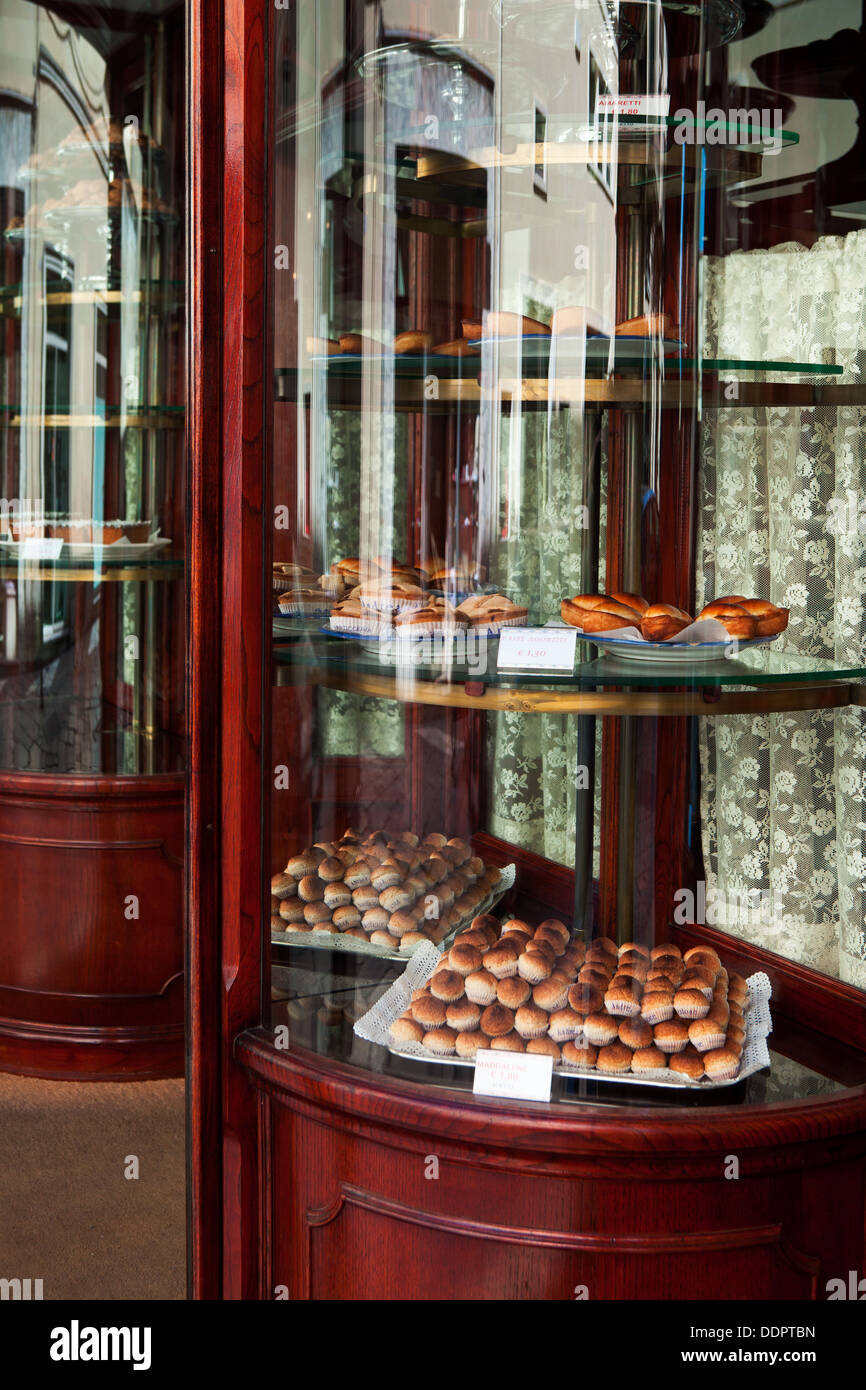 Old fashioned polished mahogany and curved glass pastry shop window ...