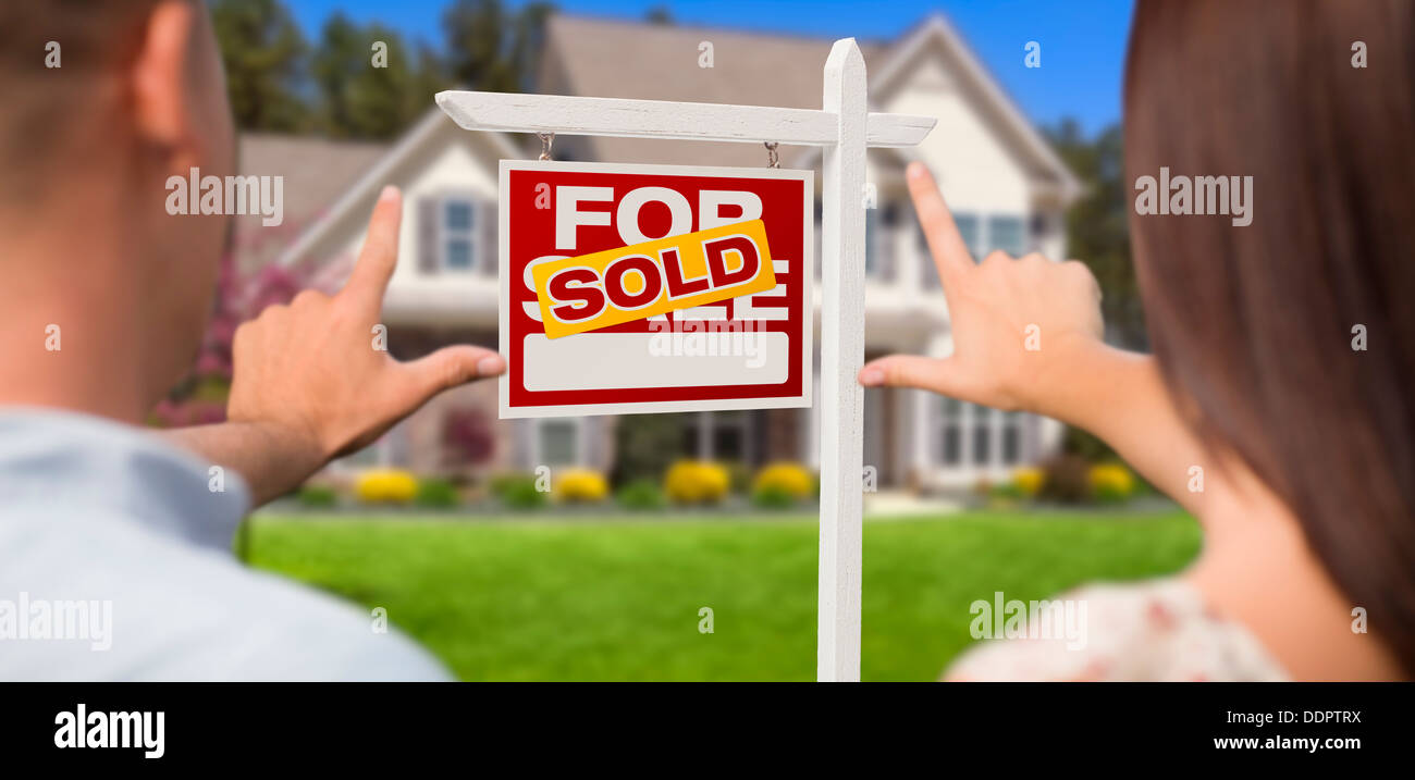 Sold For Sale Real Estate Sign, House and Military Couple Framing Hands in Front Stock Photo - Alamy